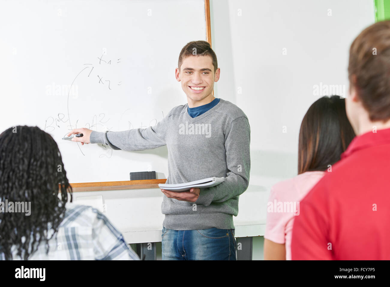 Student presents in front of the math class Stock Photo - Alamy