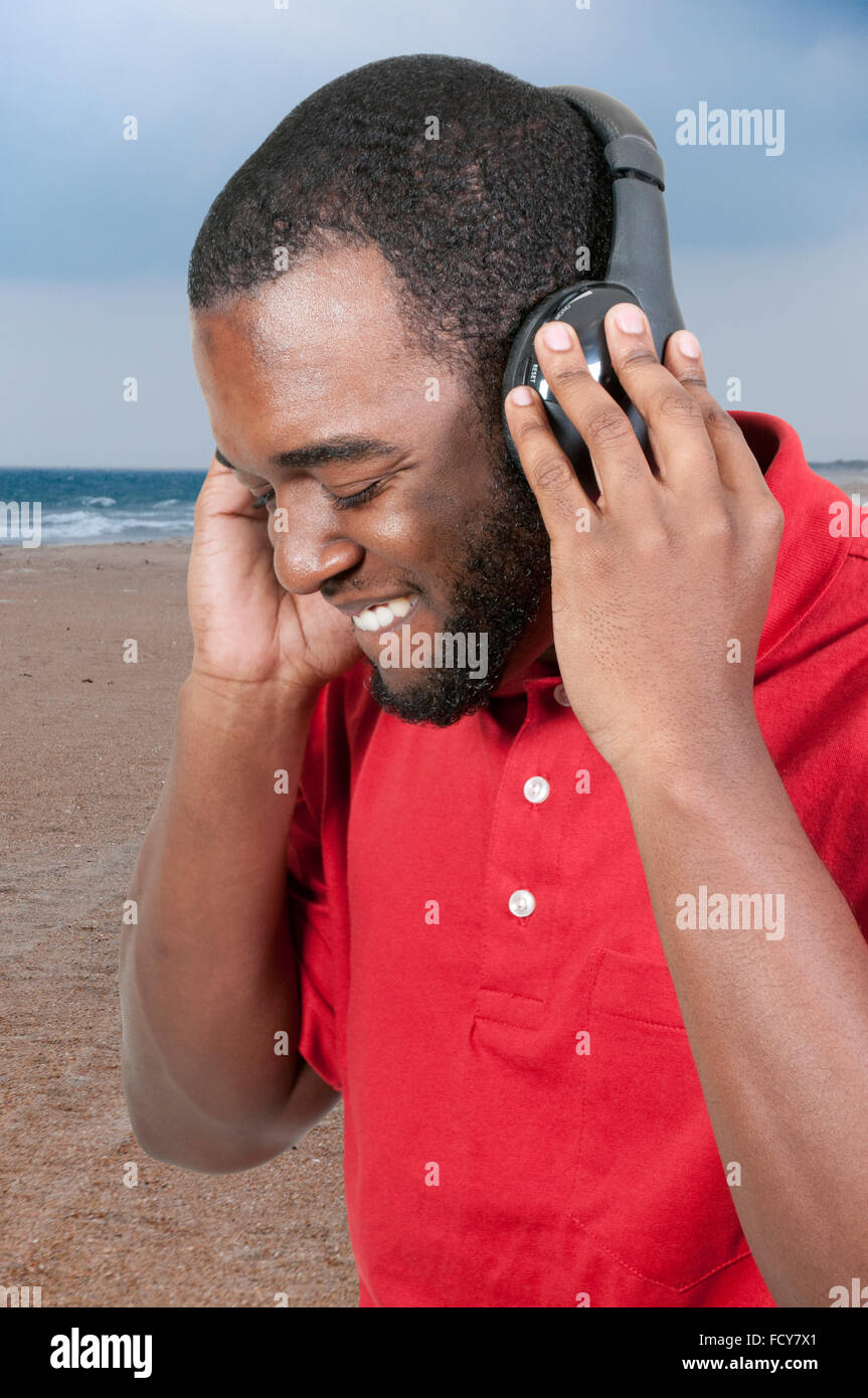 Handsome man listening to a set of headphones Stock Photo - Alamy