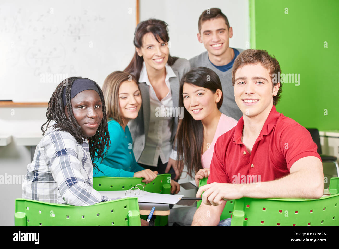 Students and teacher at class as a happy team Stock Photo - Alamy