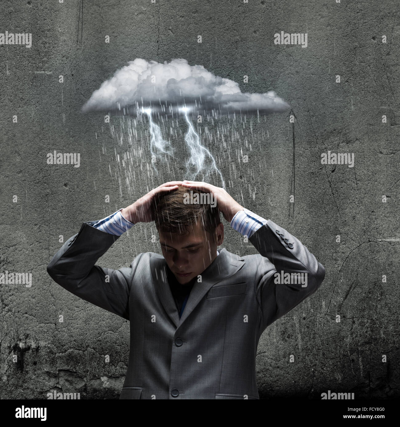 Businessman sitting under rain protecting head with arms Stock Photo ...