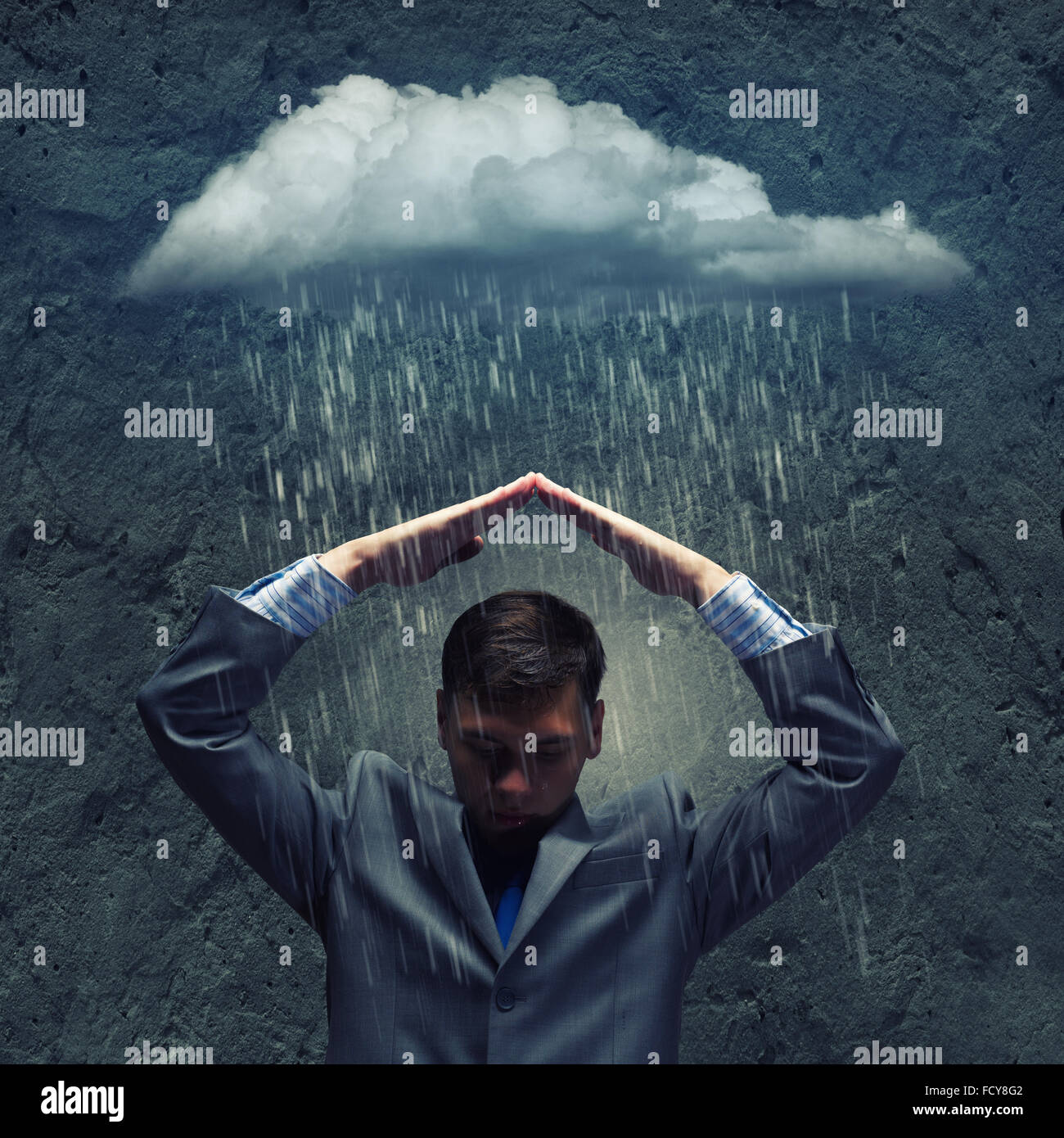 Businessman sitting under rain protecting head with arms Stock Photo ...