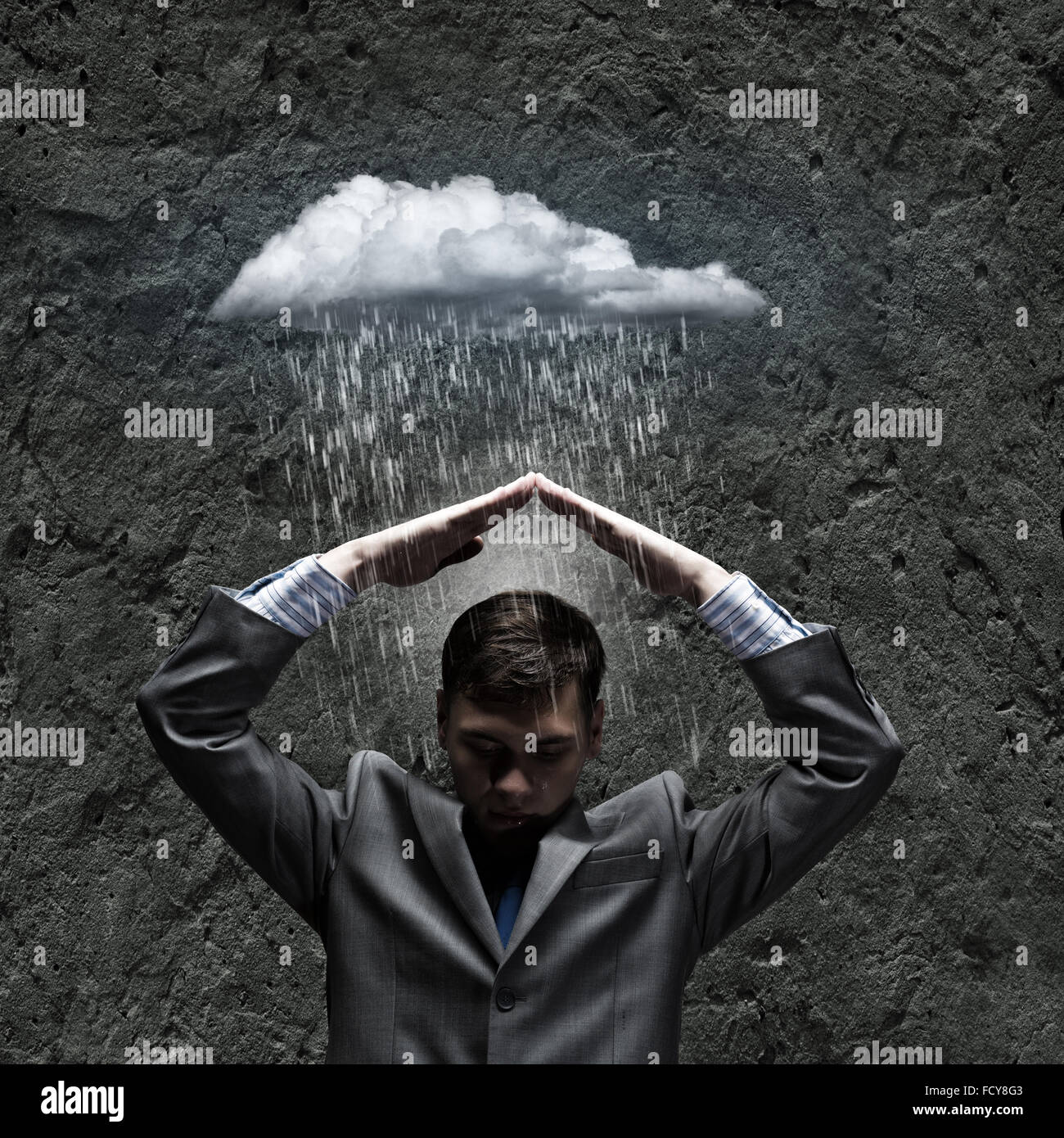 Businessman sitting under rain protecting head with arms Stock Photo ...
