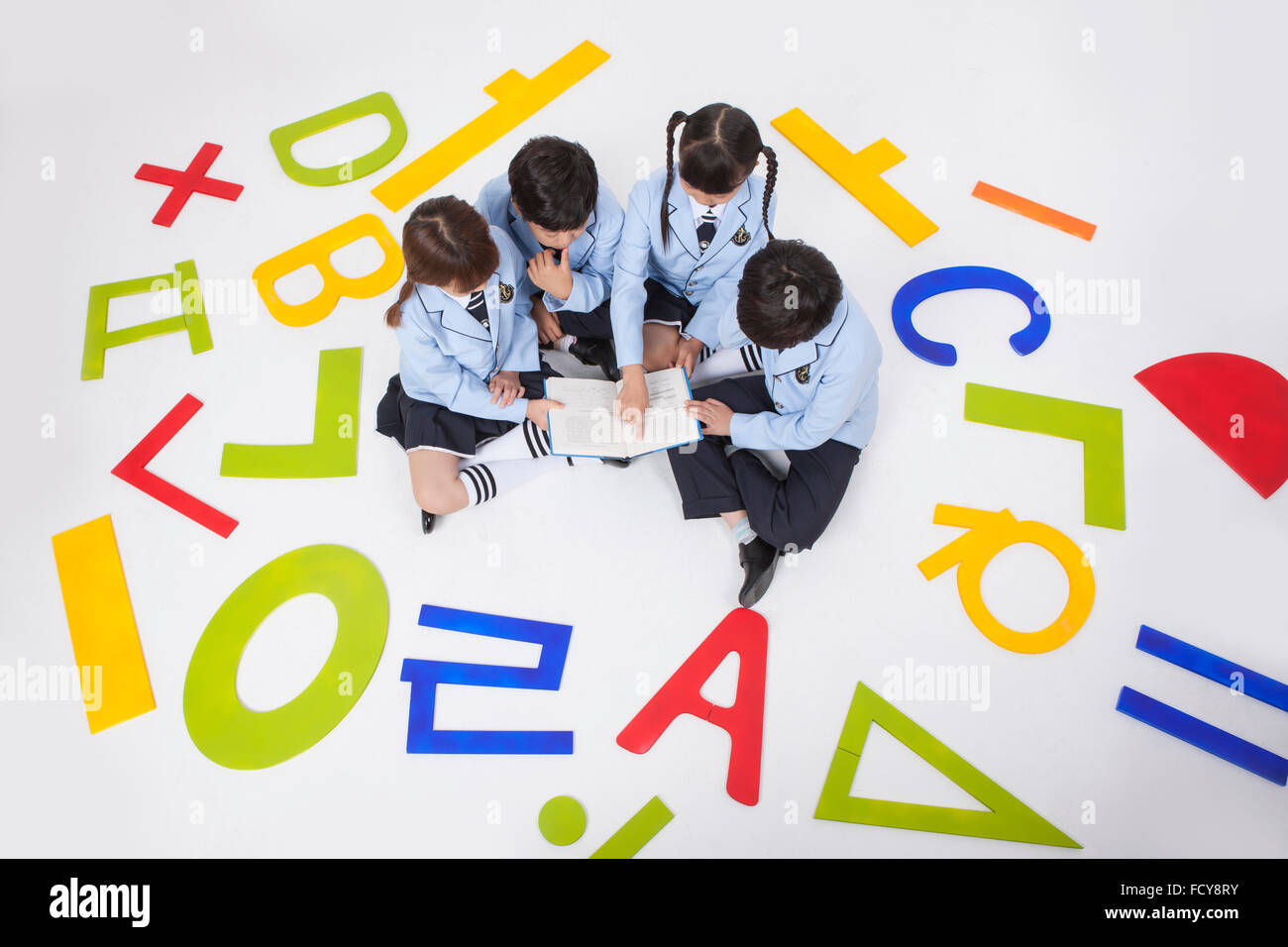 High angle of four elementary school students in school uniform ...