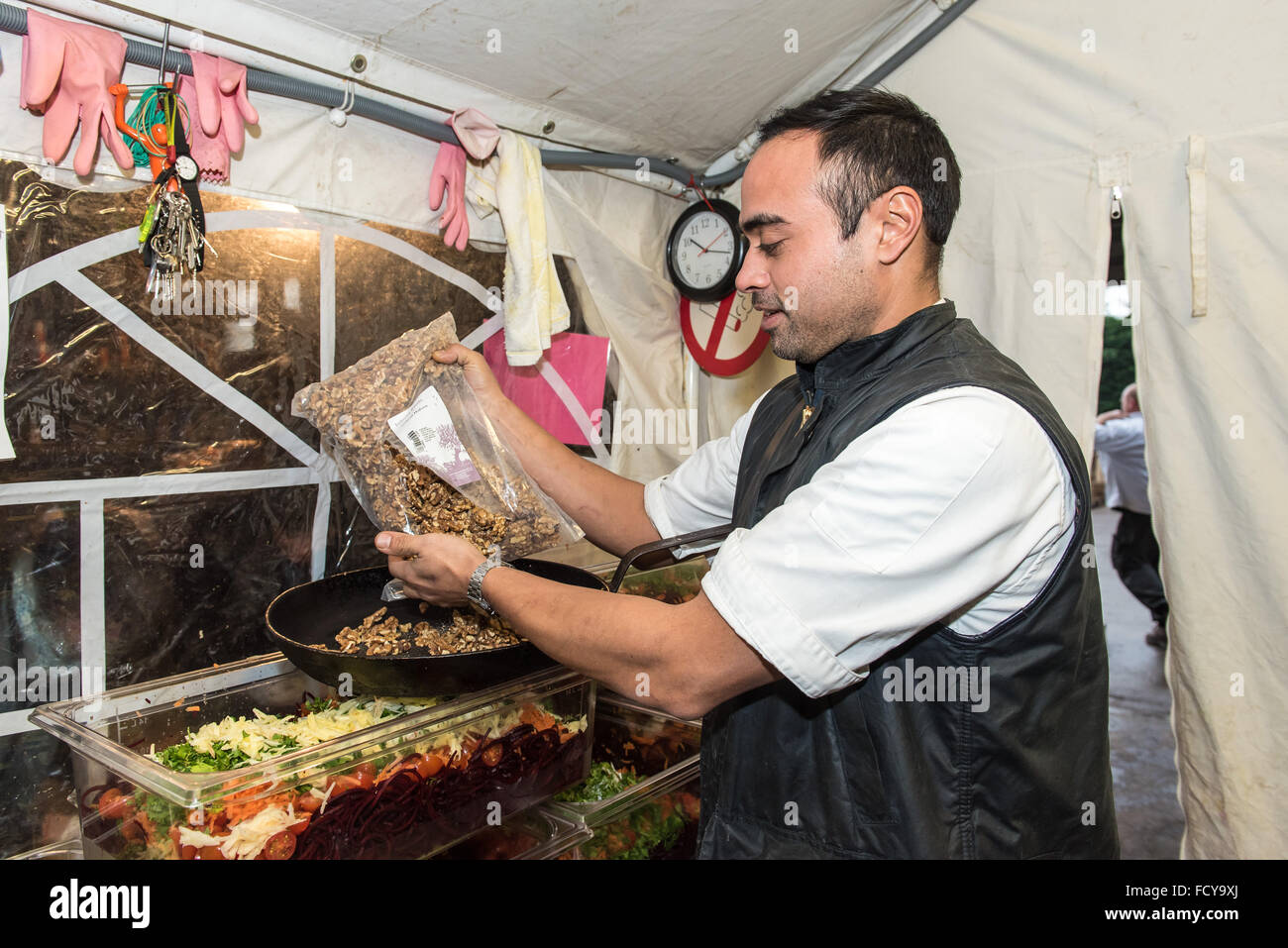 Volunteer chef Kevin Mikalian starts to prepare a dish with nuts ...