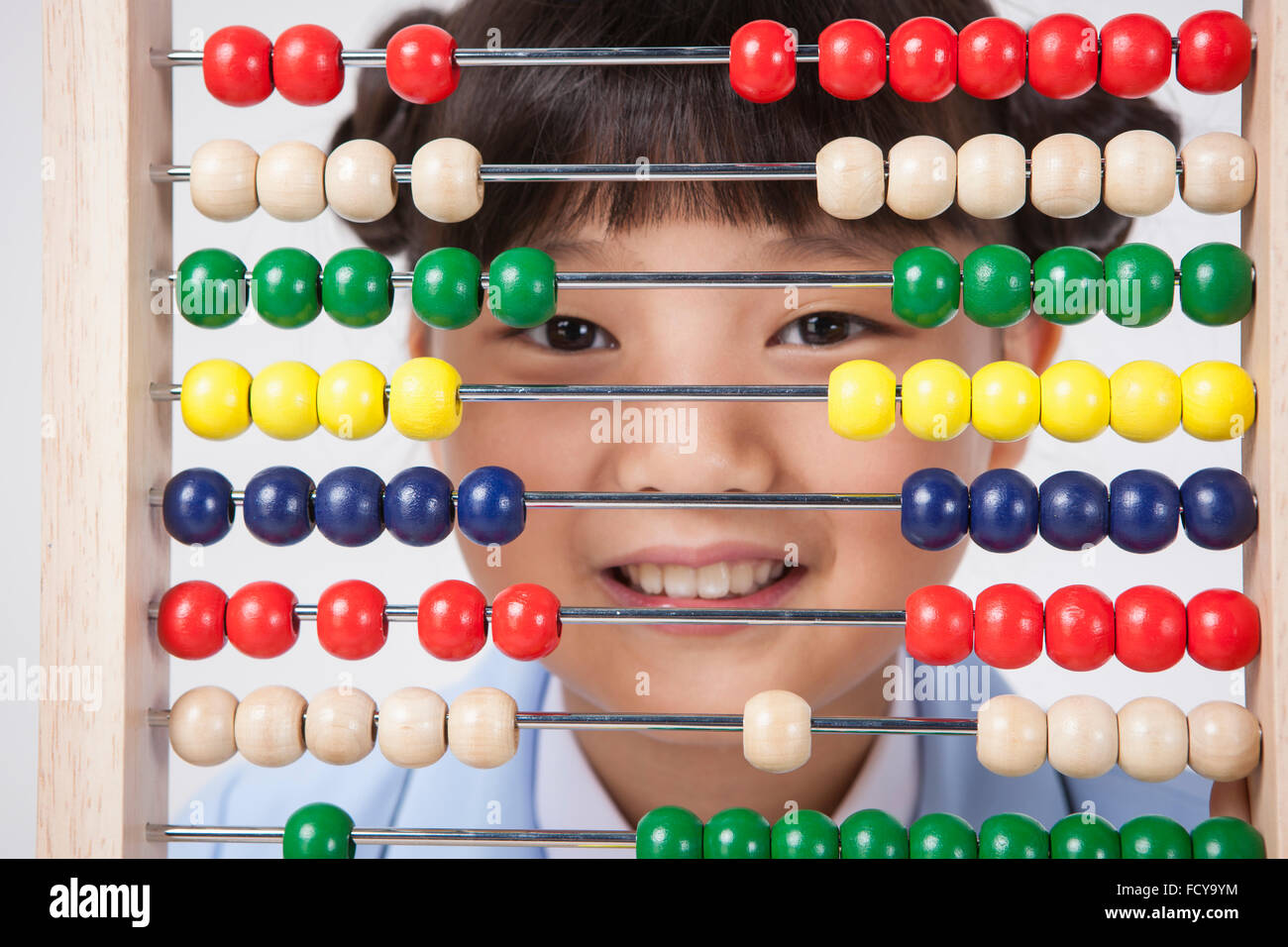 Elementary school boy looking through colorful abacus Stock Photo - Alamy