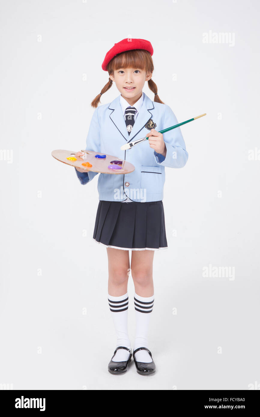 Elementary school girl in school uniforms and red beret standing and ...
