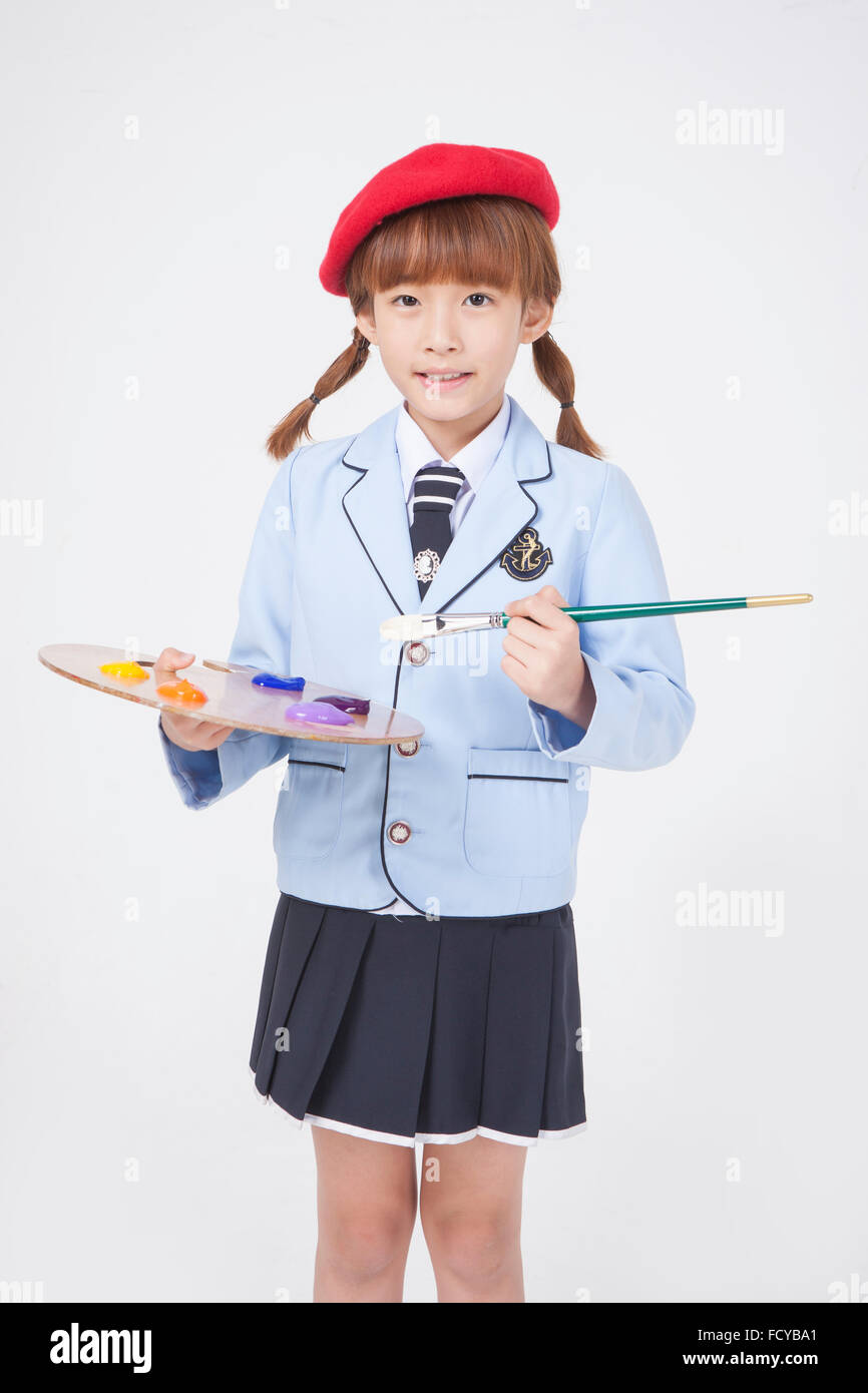 Elementary school girl in school uniforms and red beret holding drawing ...