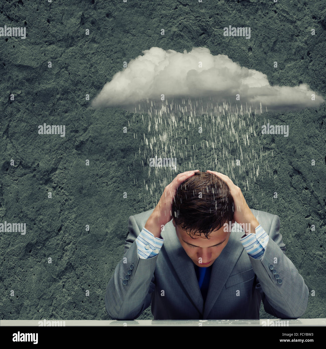 Depressed young businessman sitting wet under rain Stock Photo - Alamy