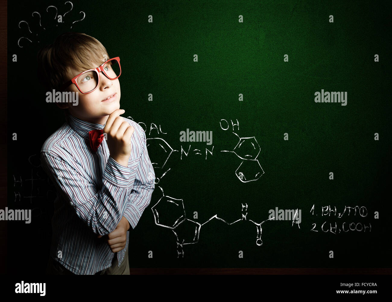 Genius boy in red glasses near blackboard with formulas Stock Photo - Alamy