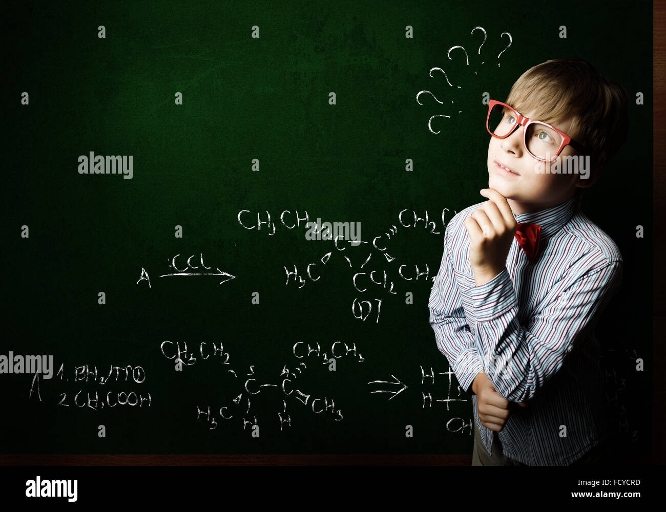 Genius boy in red glasses near blackboard with formulas Stock Photo - Alamy