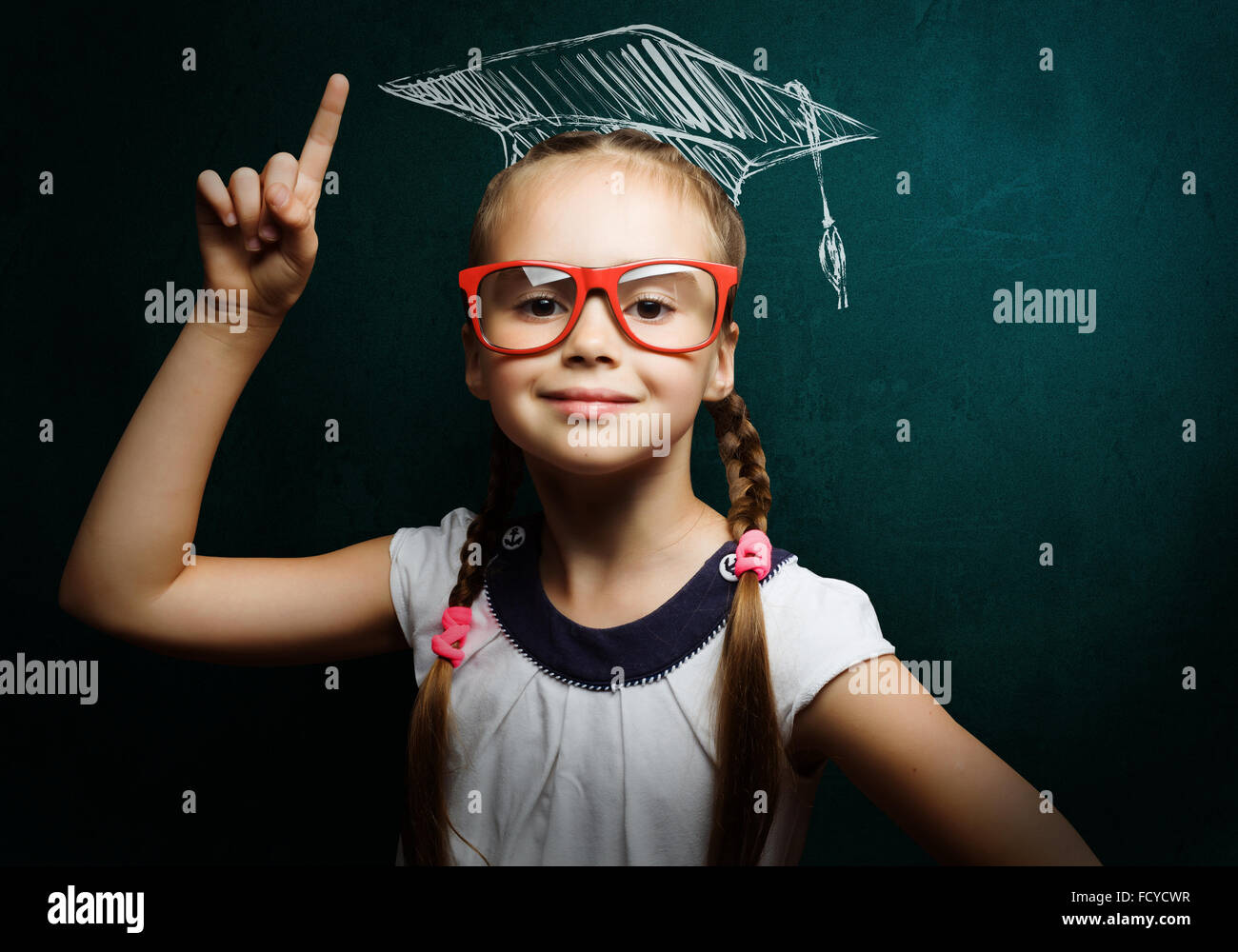 Genius girl in red glasses near blackboard in master hat Stock Photo ...