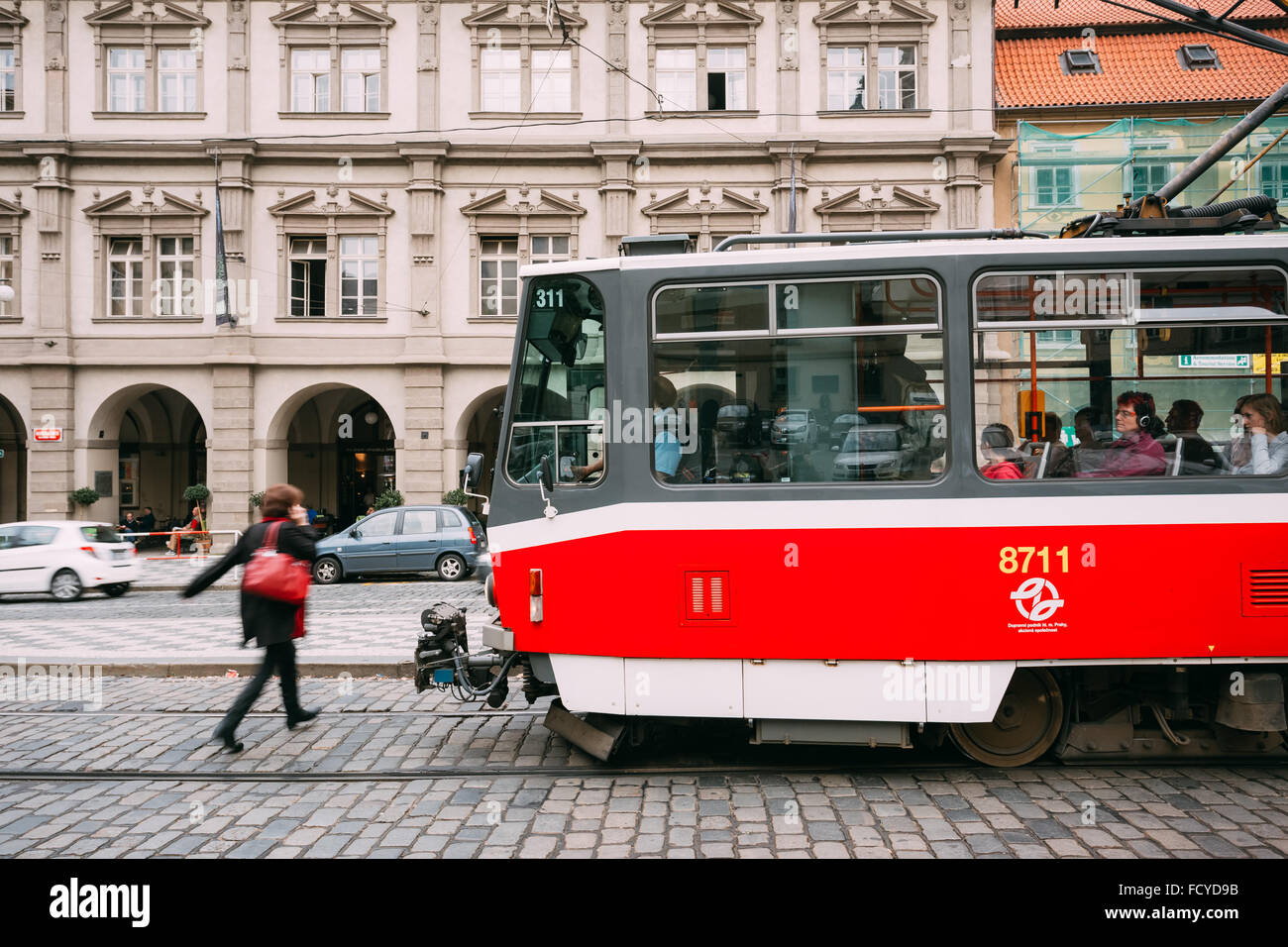 Prague, Czech Republic - October 10, 2014: People cross the tram tracks ...
