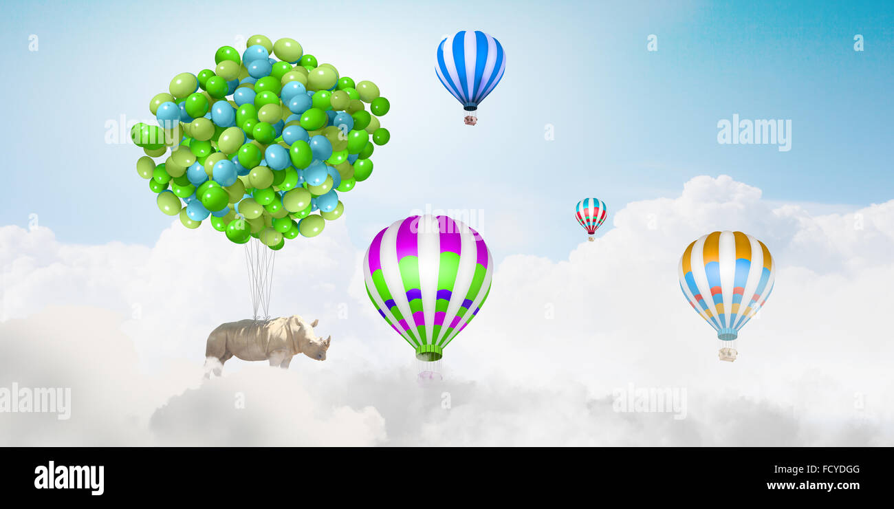 Rhino flying high in sky on bunch of colorful balloons Stock Photo - Alamy