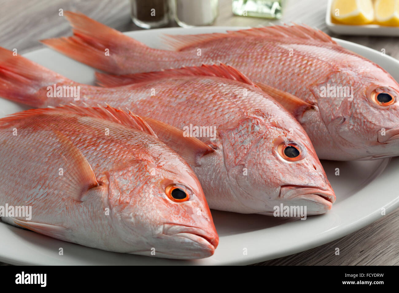 Fresh raw red snappers on a dish close up Stock Photo - Alamy