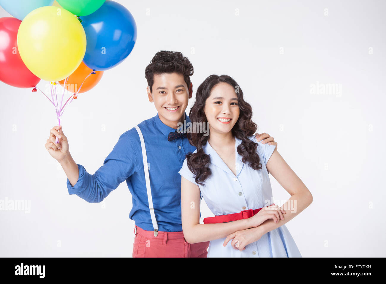 Couple in retro style staring forward with a smile with colorful ...