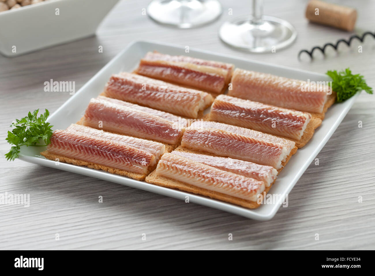 Dish with filleted smoked eel on toast as a party snack Stock Photo - Alamy