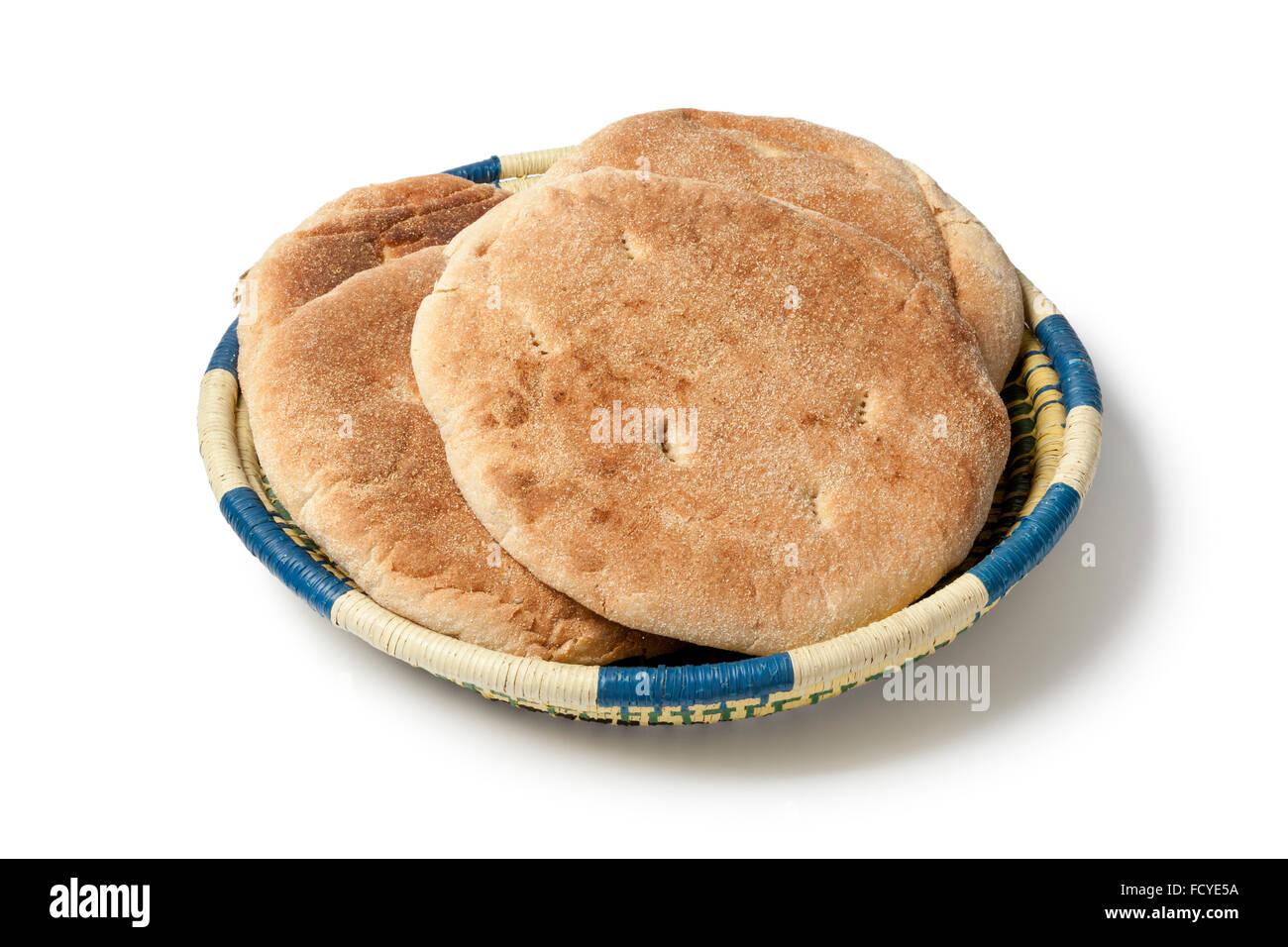 Traditional Moroccan farmers bread in a basket on white background ...