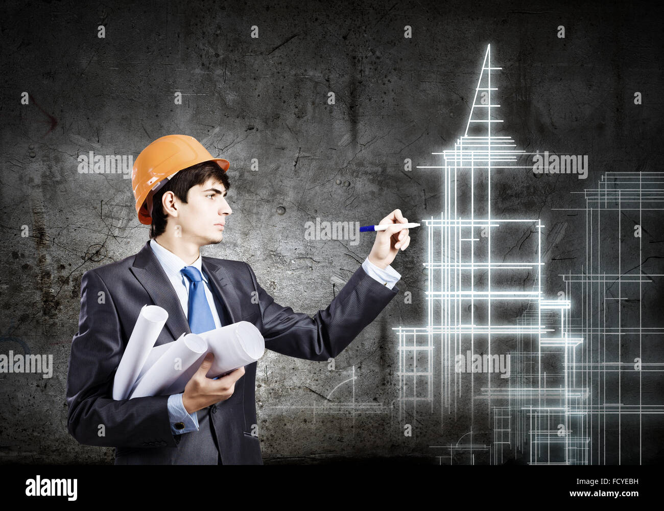 Young man engineer in helmet drawing construction project Stock Photo ...