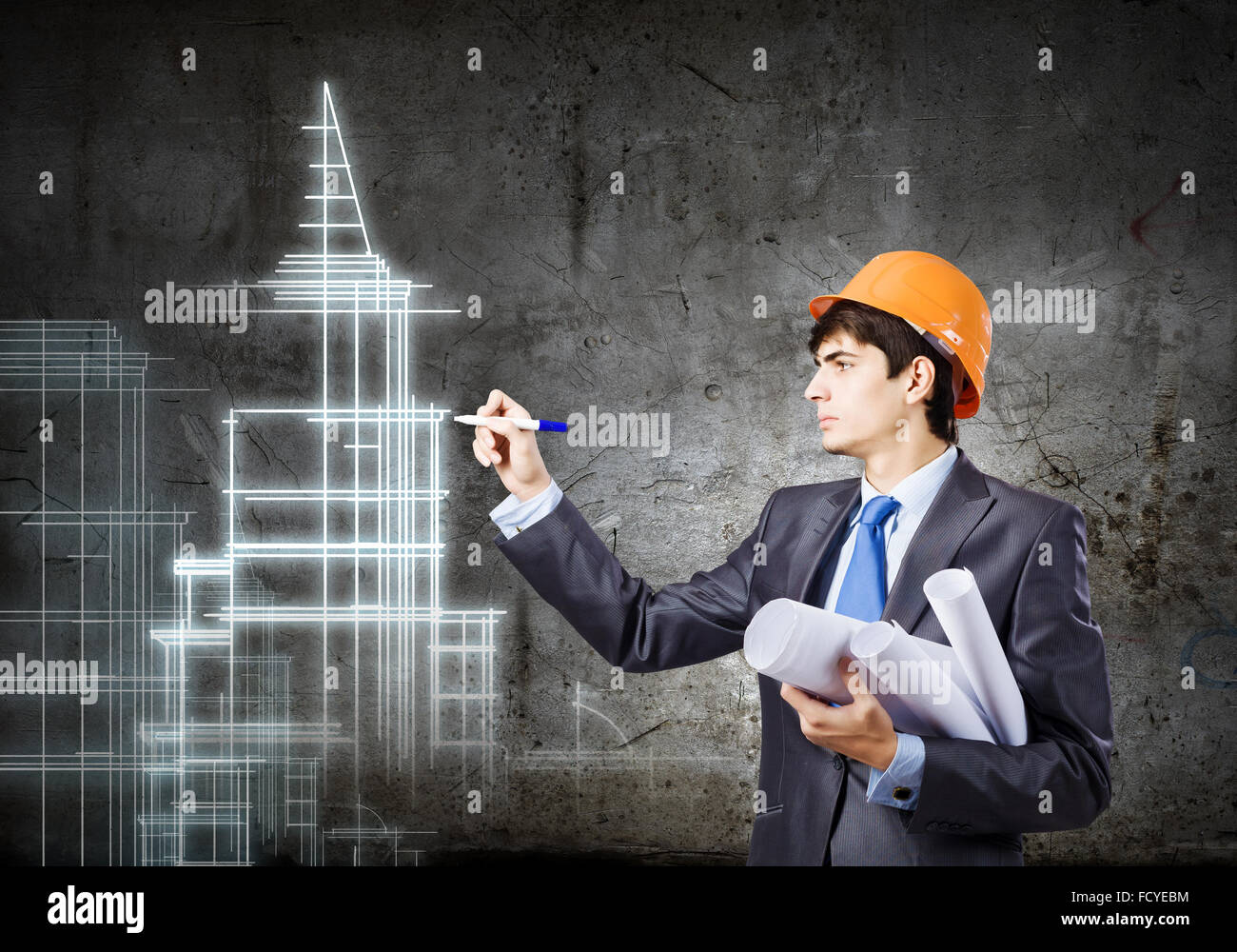 Young man engineer in helmet drawing construction project Stock Photo ...
