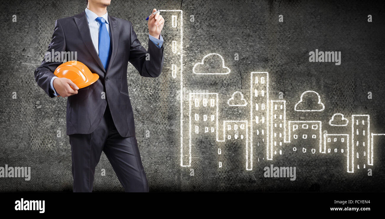 Young man engineer in helmet drawing construction project Stock Photo ...