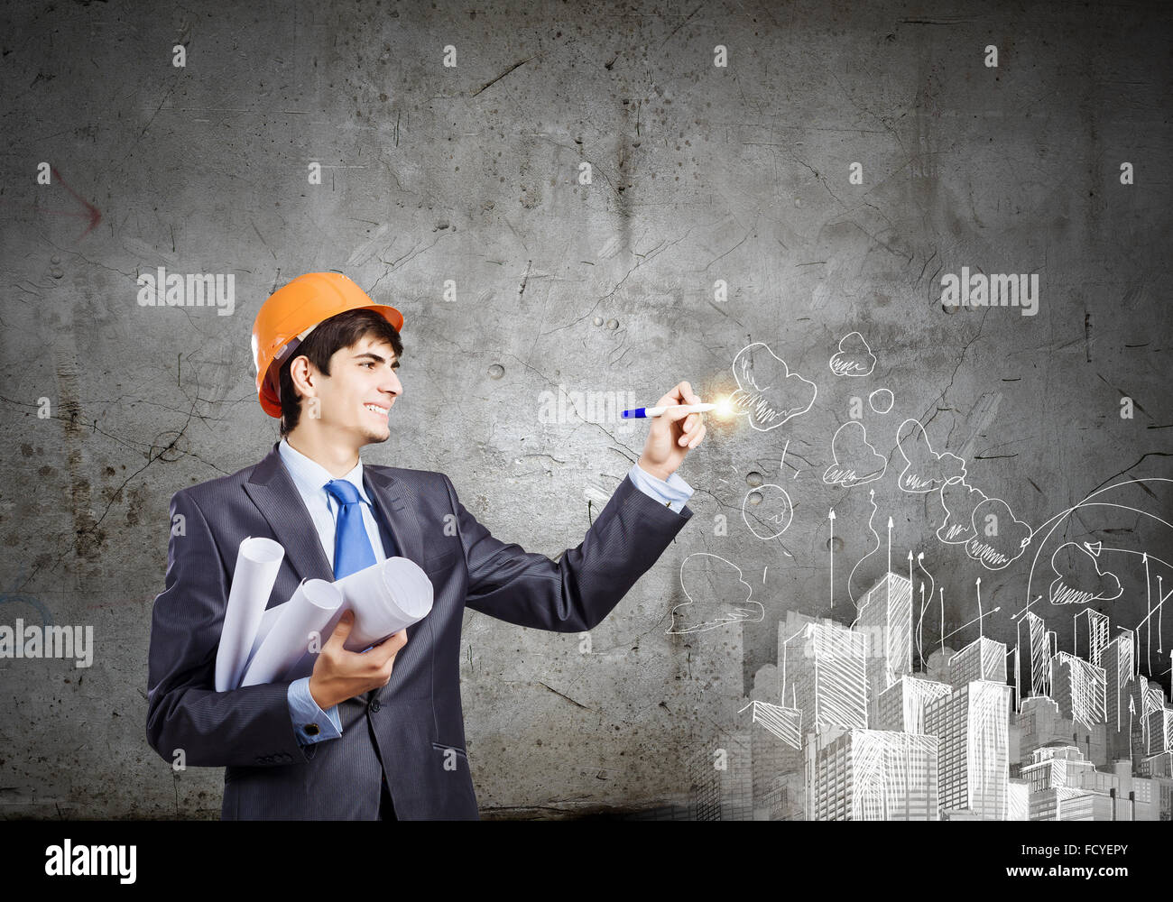 Young man engineer in helmet drawing construction project Stock Photo ...