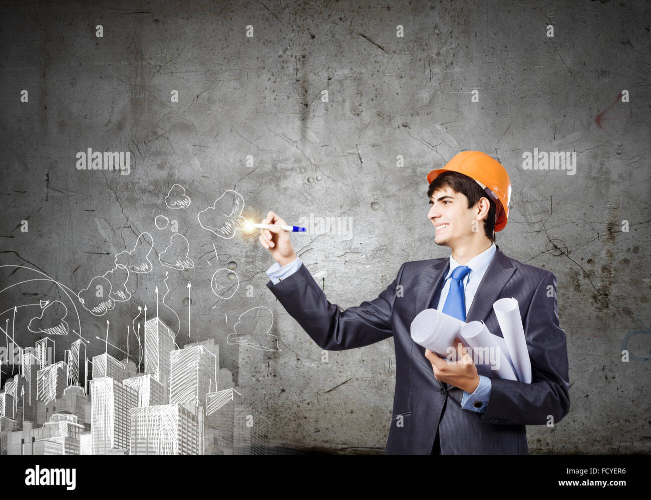Young man engineer in helmet drawing construction project Stock Photo ...