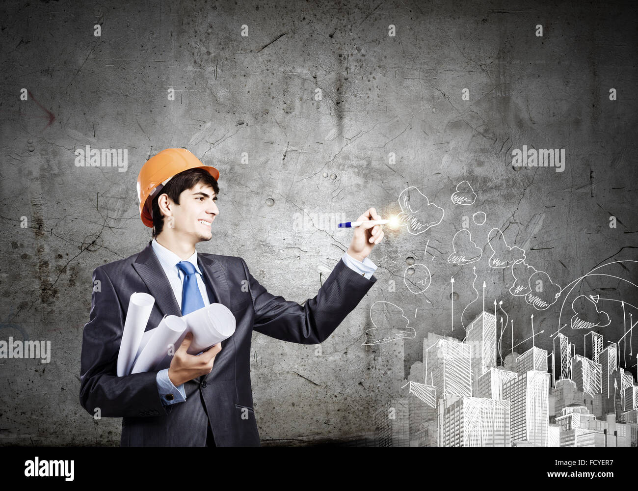 Young man engineer in helmet drawing construction project Stock Photo - Alamy