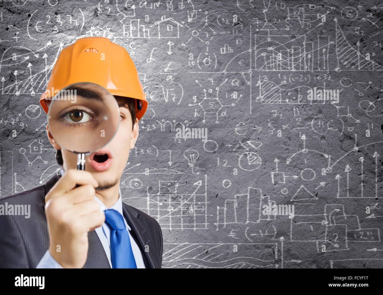 Young man engineer with magnifier against sketch background Stock Photo ...