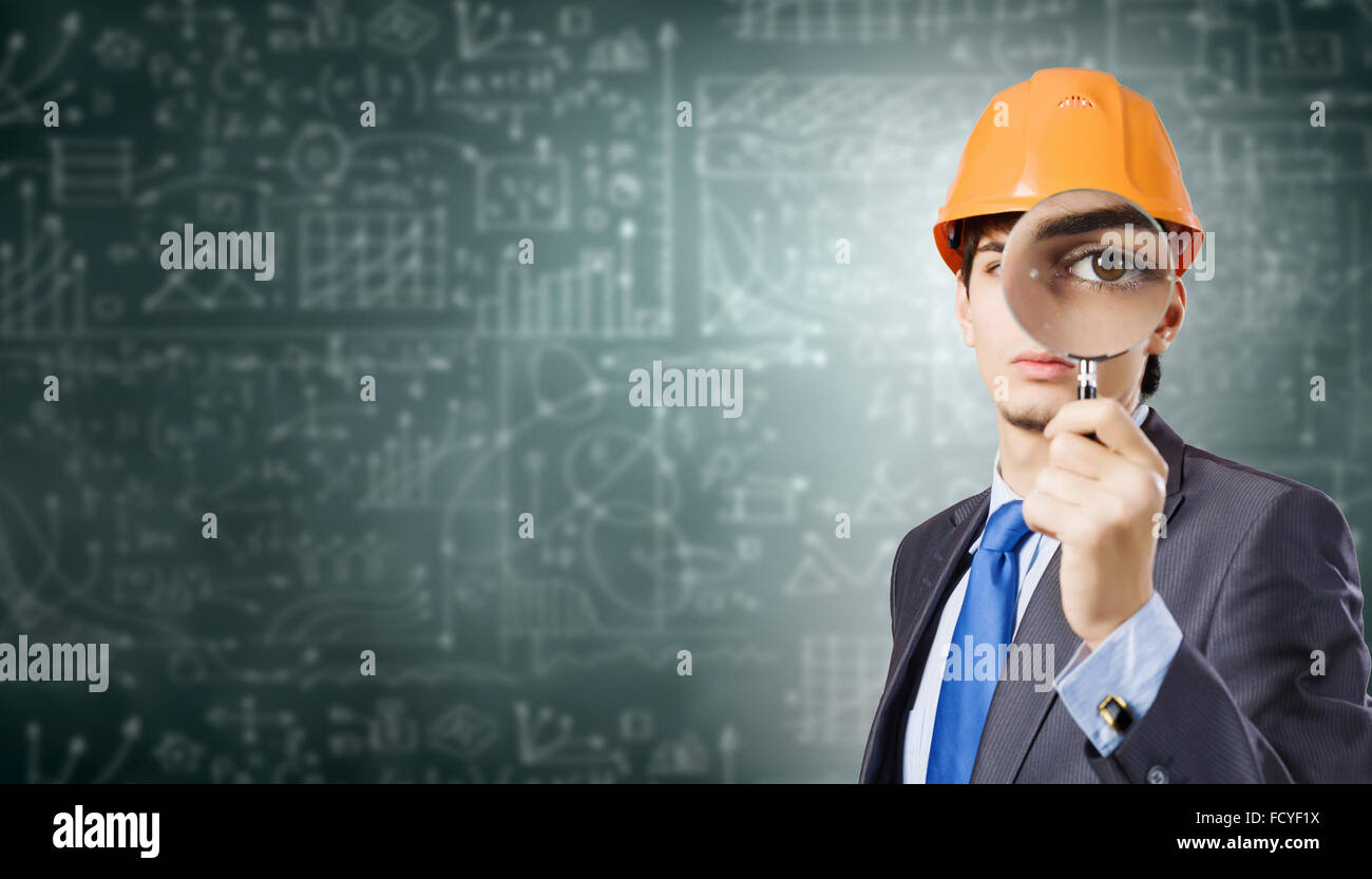Young man engineer with magnifier against sketch background Stock Photo ...