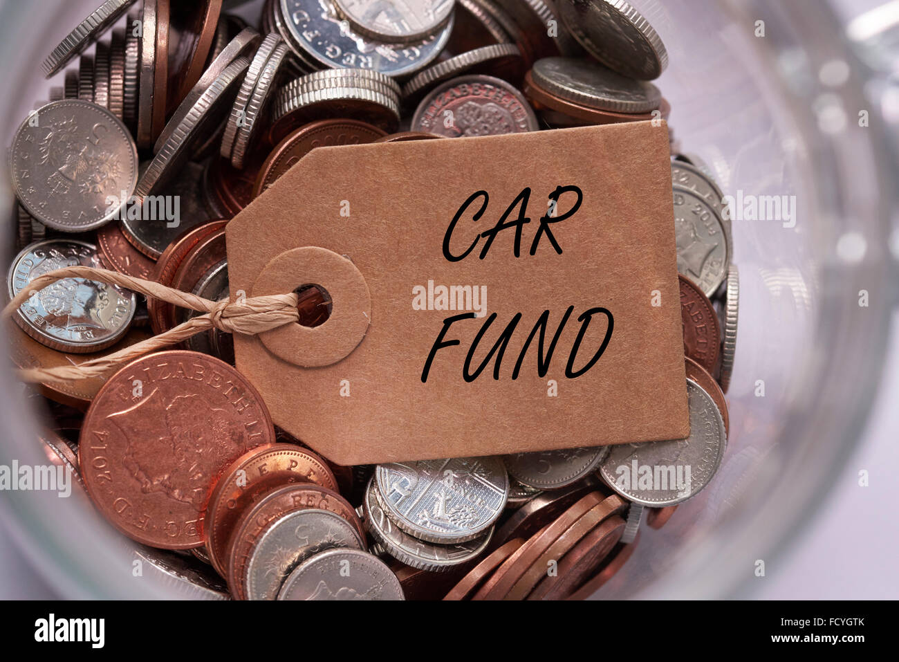 Car fund label on British mixed coins inside a glass jar concept Stock ...