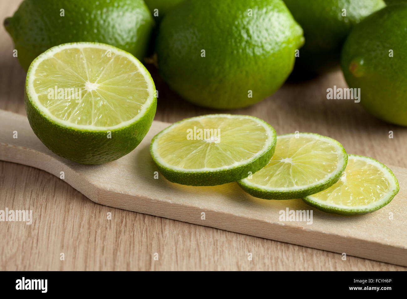 Fresh cut green limes on a cutting board Stock Photo - Alamy