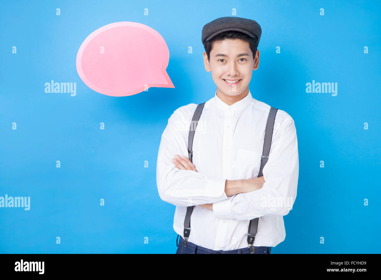 Man in retro style fashion with his arms folded and staring forward ...