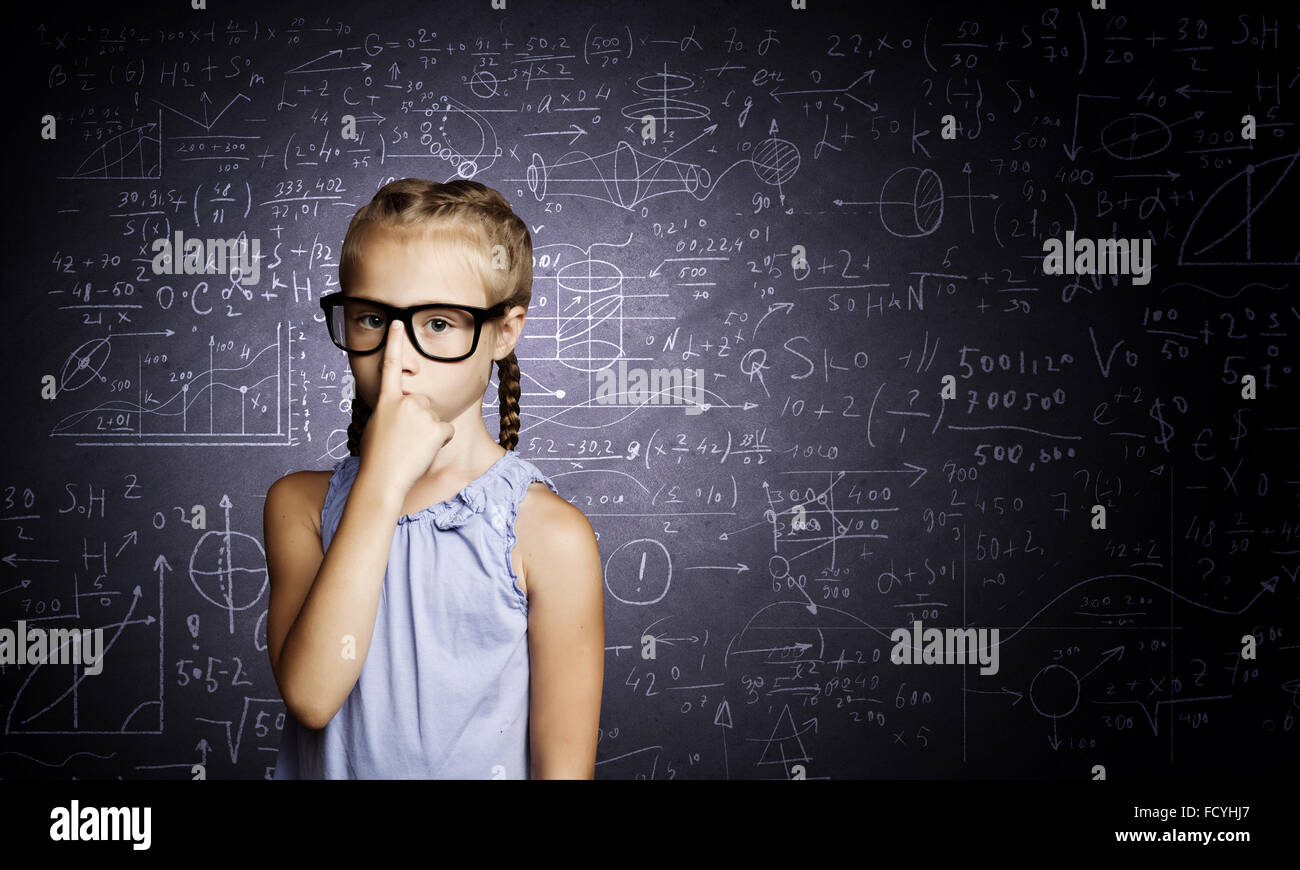 Genius girl in red glasses near blackboard with formulas Stock Photo ...