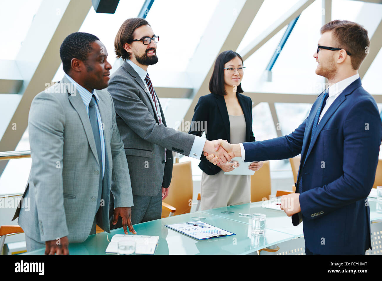 Two happy business partners handshaking after making agreement Stock ...