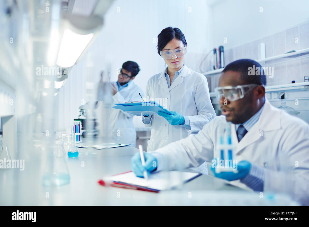 Young scientists analyzing substances in laboratory Stock Photo - Alamy