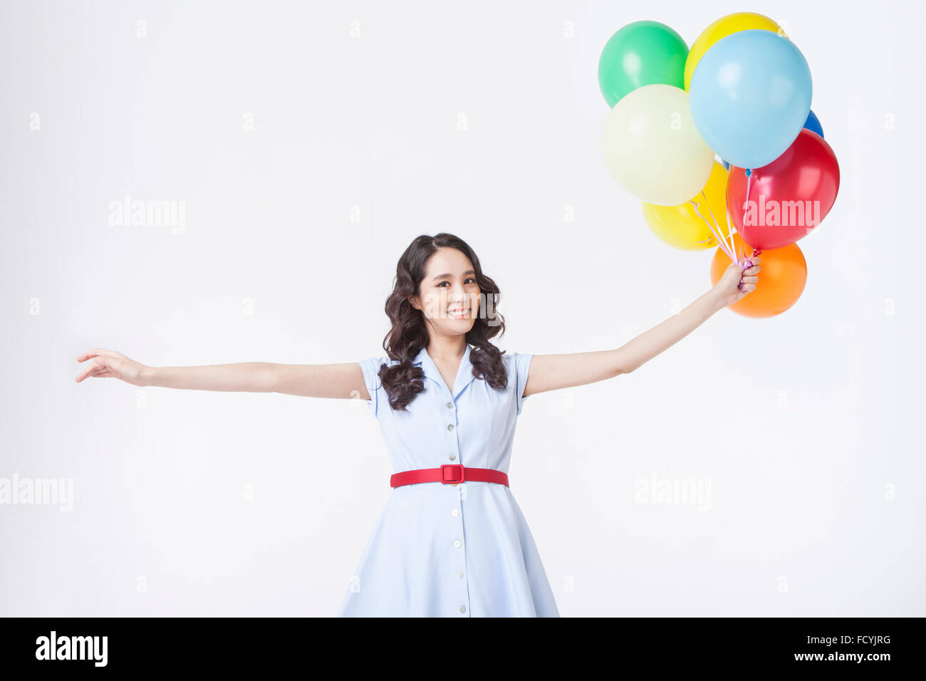 Woman in retro style outfits staring forward with a smile with colorful ...