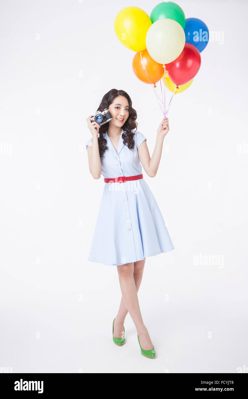 Woman in retro style outfits standing and staring forward with a smile ...