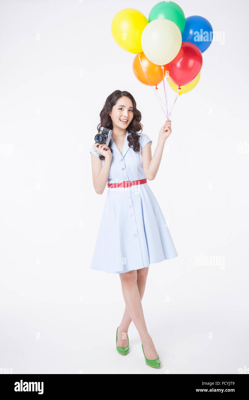 Woman in retro style outfits standing and staring forward with a smile ...