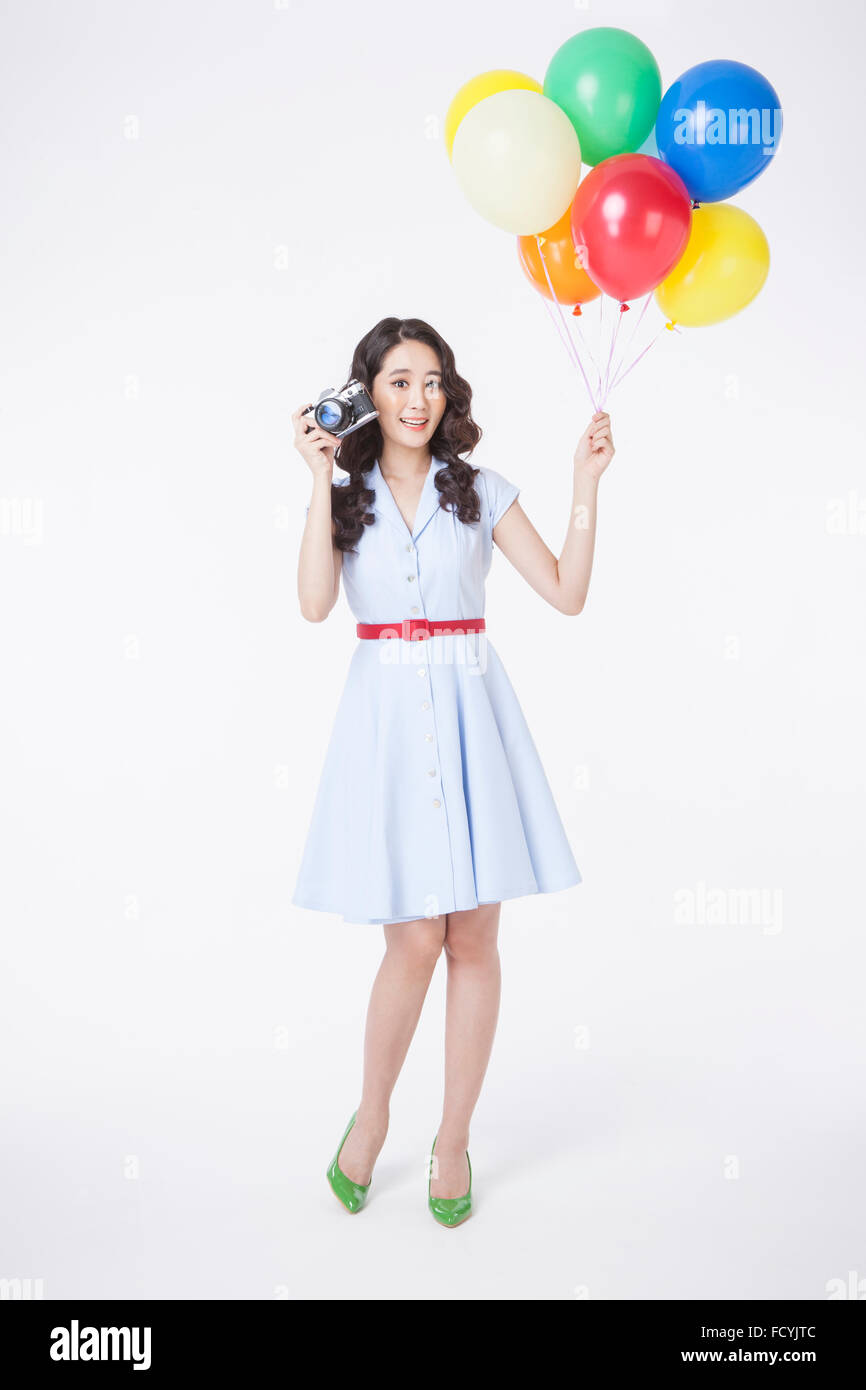 Woman in retro style outfits standing and staring forward with a smile ...