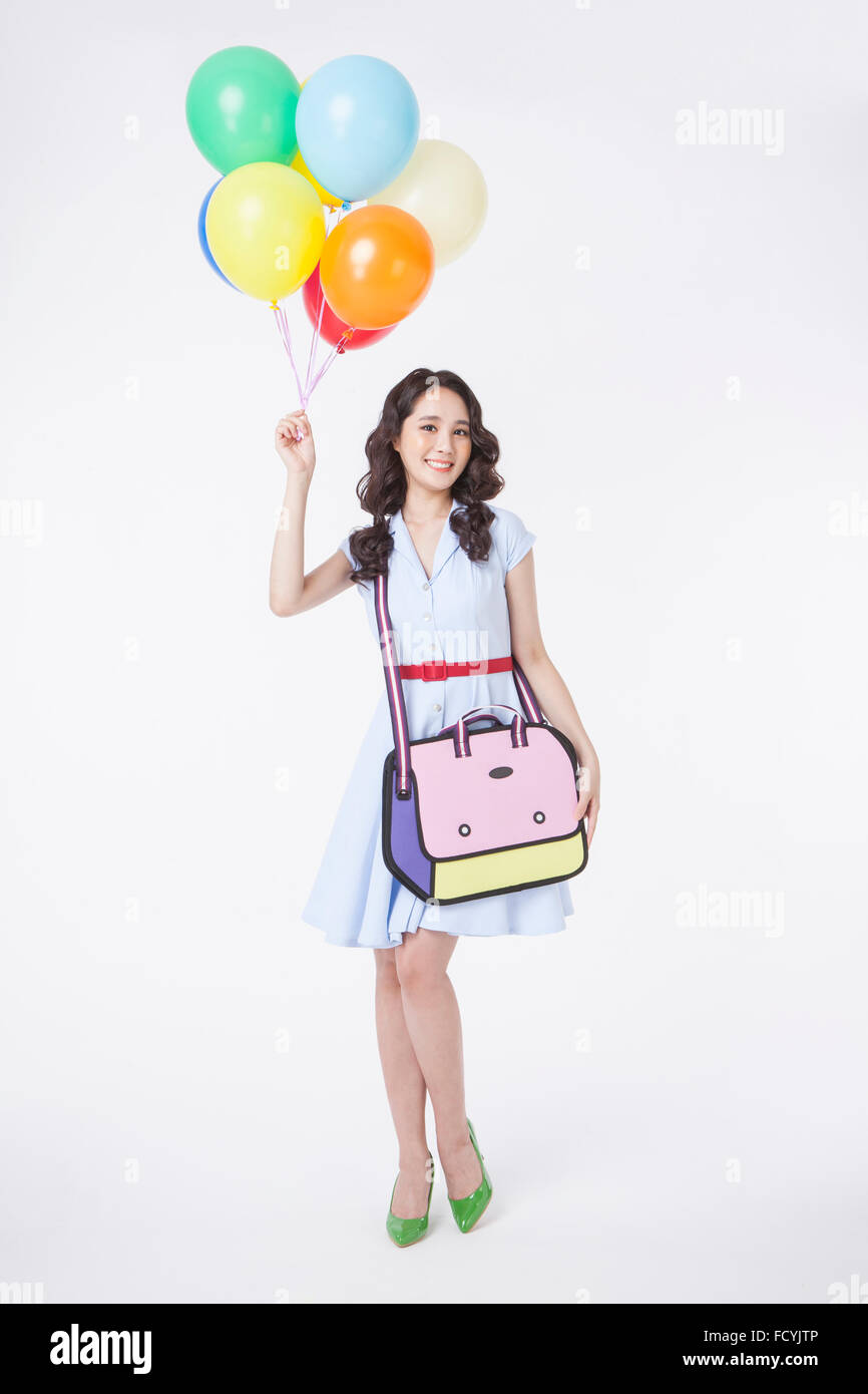 Woman in retro style outfits standing and staring forward with a smile ...