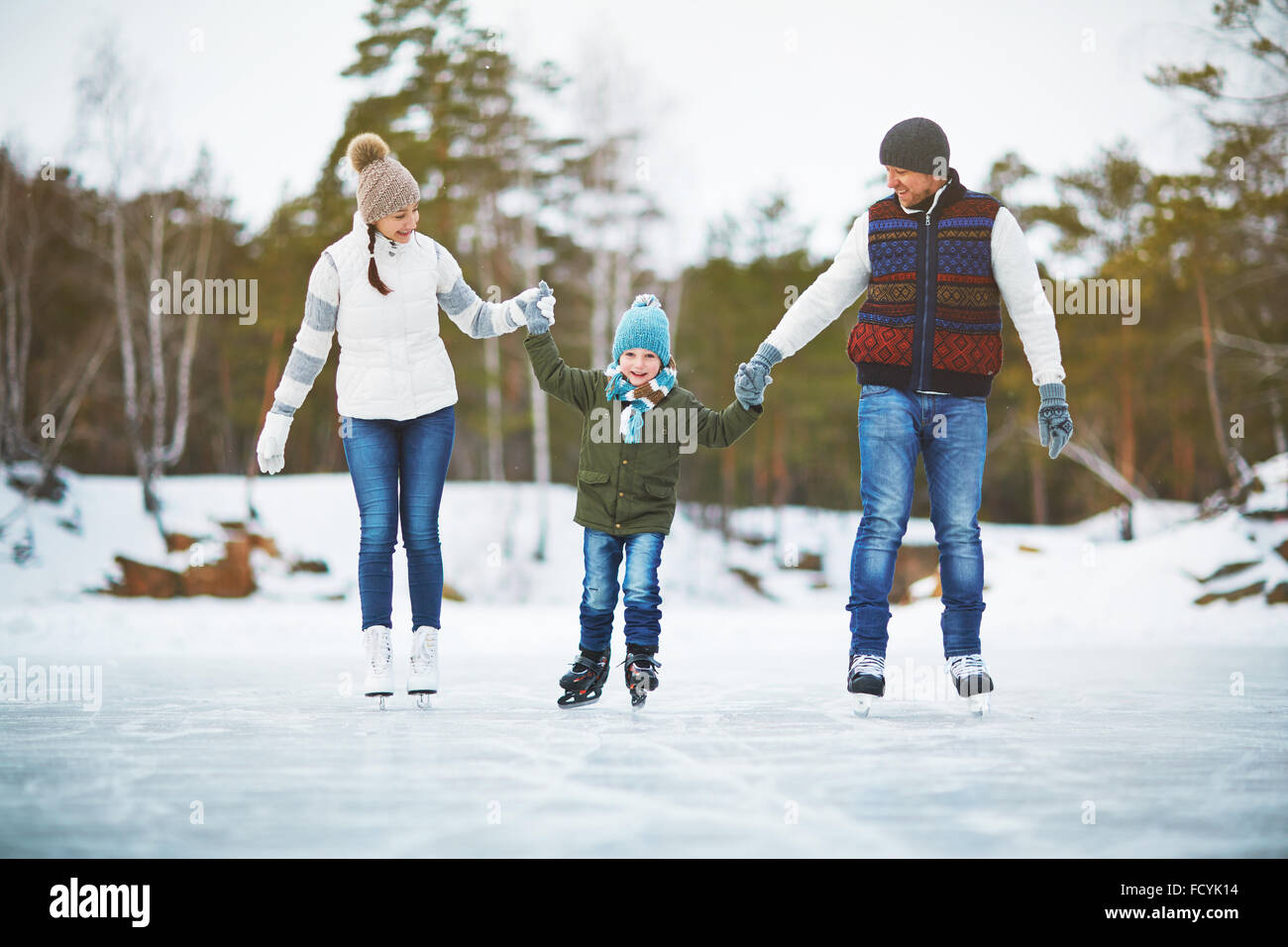 Family of three skating together on the rink at leisure Stock Photo - Alamy