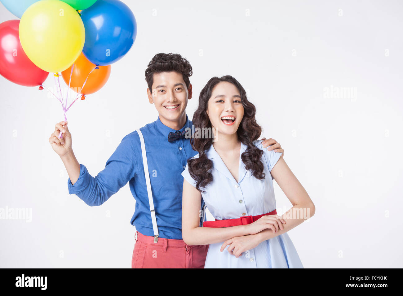 Couple in retro style outfits staring forward together with a smile ...