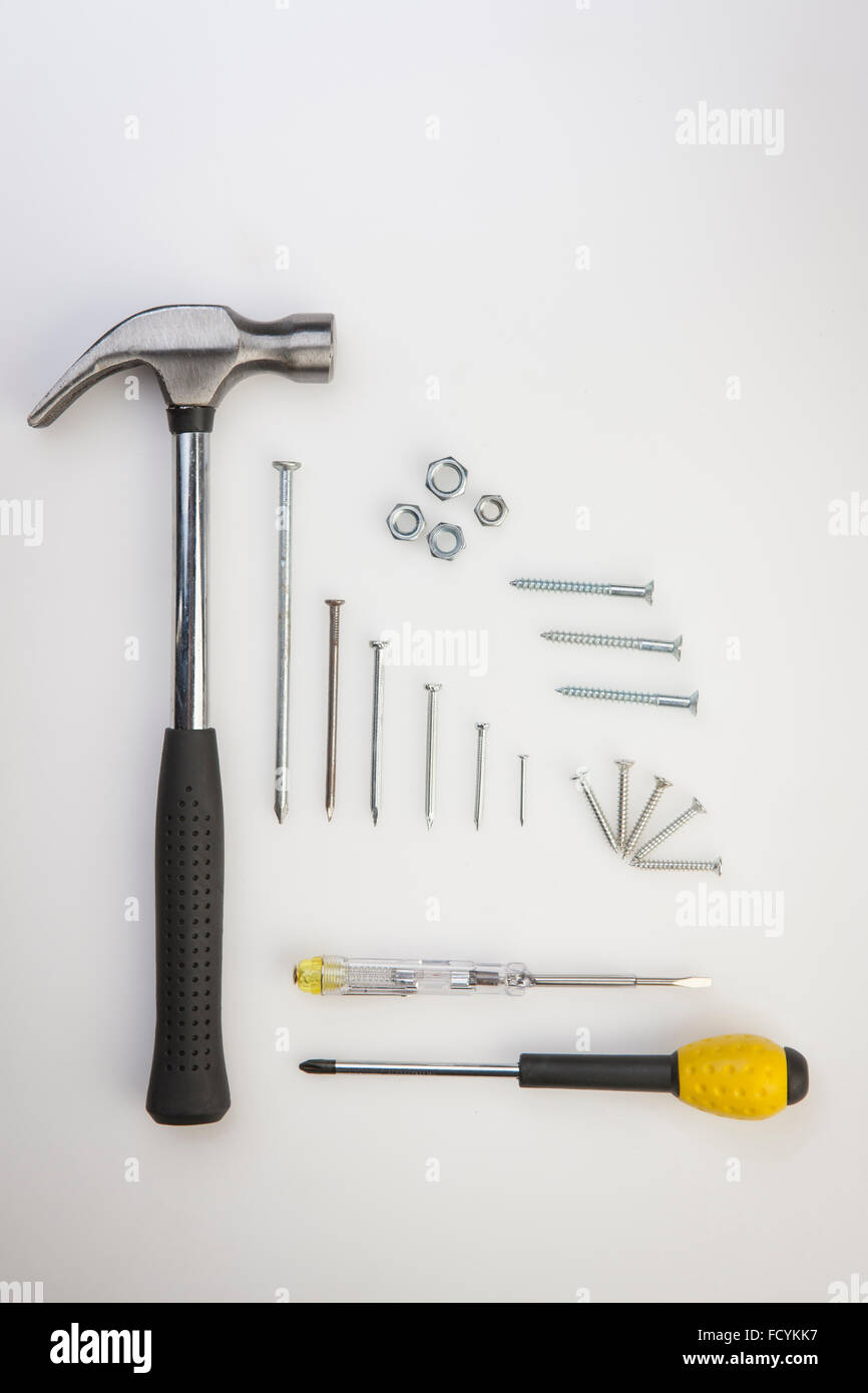 High angle of tools arranged on a white background including a hammer ...