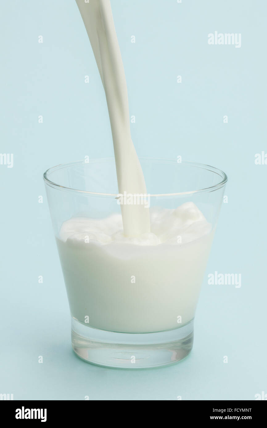 Milk being poured into a glass Stock Photo - Alamy