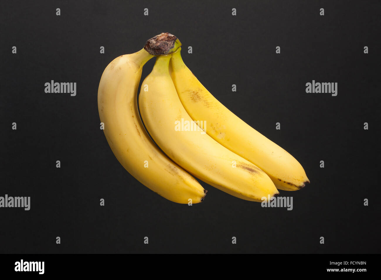 Three yellow bananas Stock Photo - Alamy
