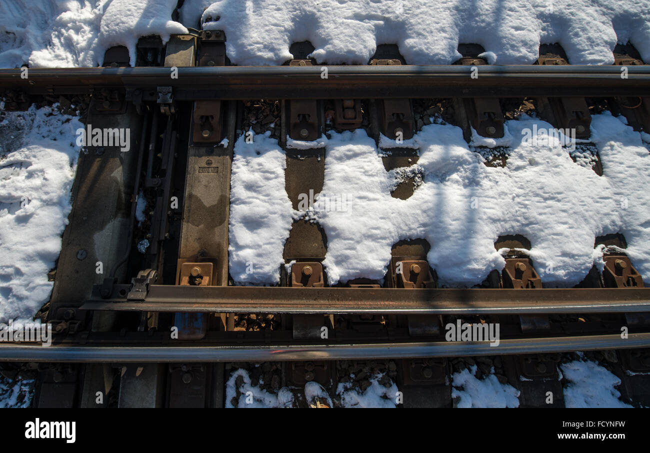 A snow-covered railway switch equipped with a heater pictured at the ...