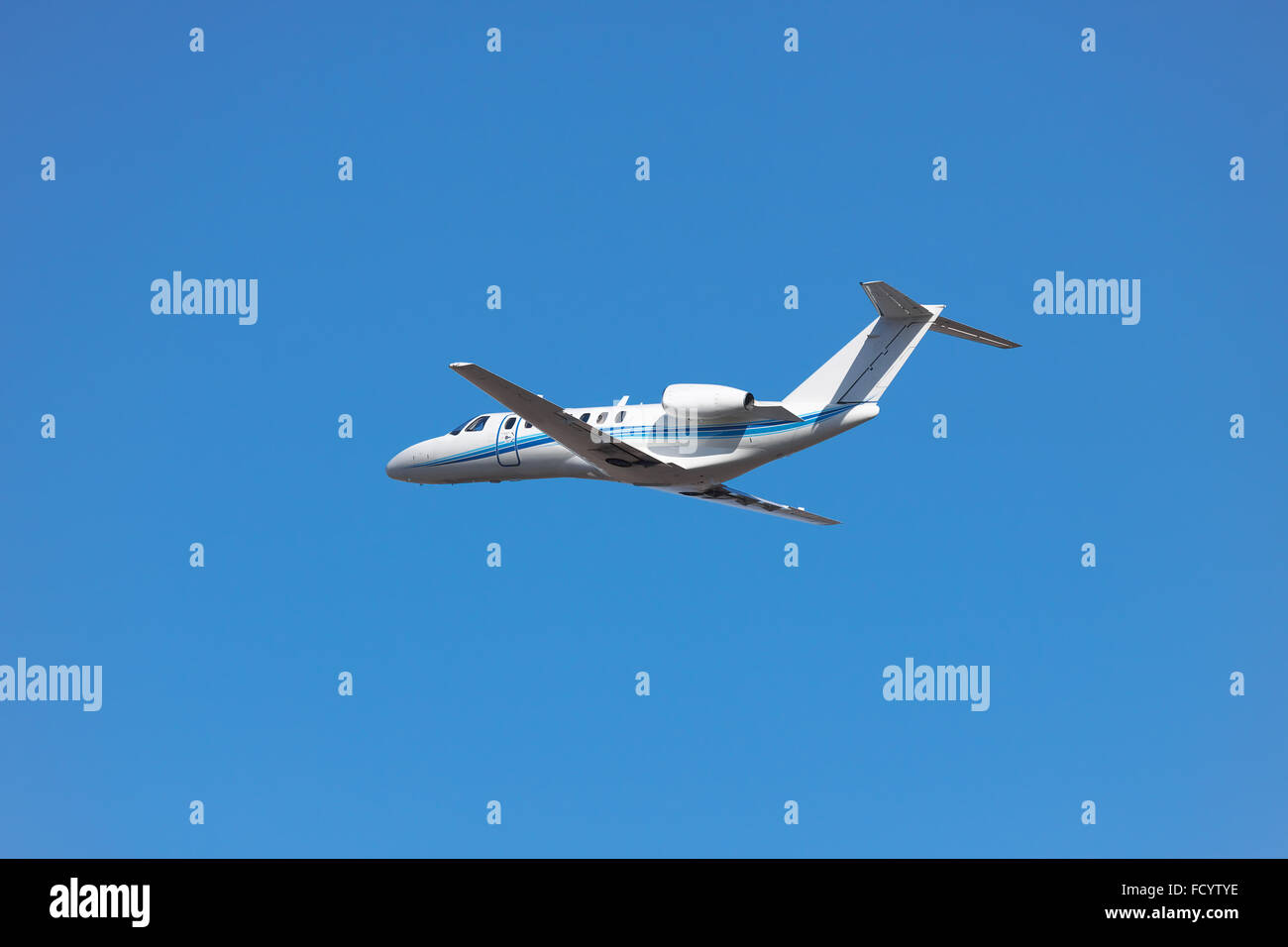 Private business jet has just taken off into the blue morning sky Stock ...