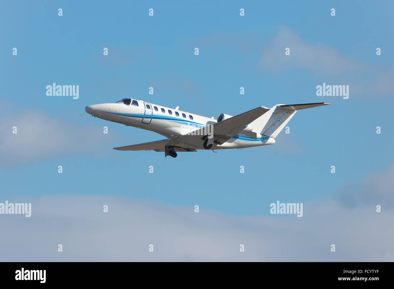 Private business jet has just taken off into the blue sky Stock Photo ...