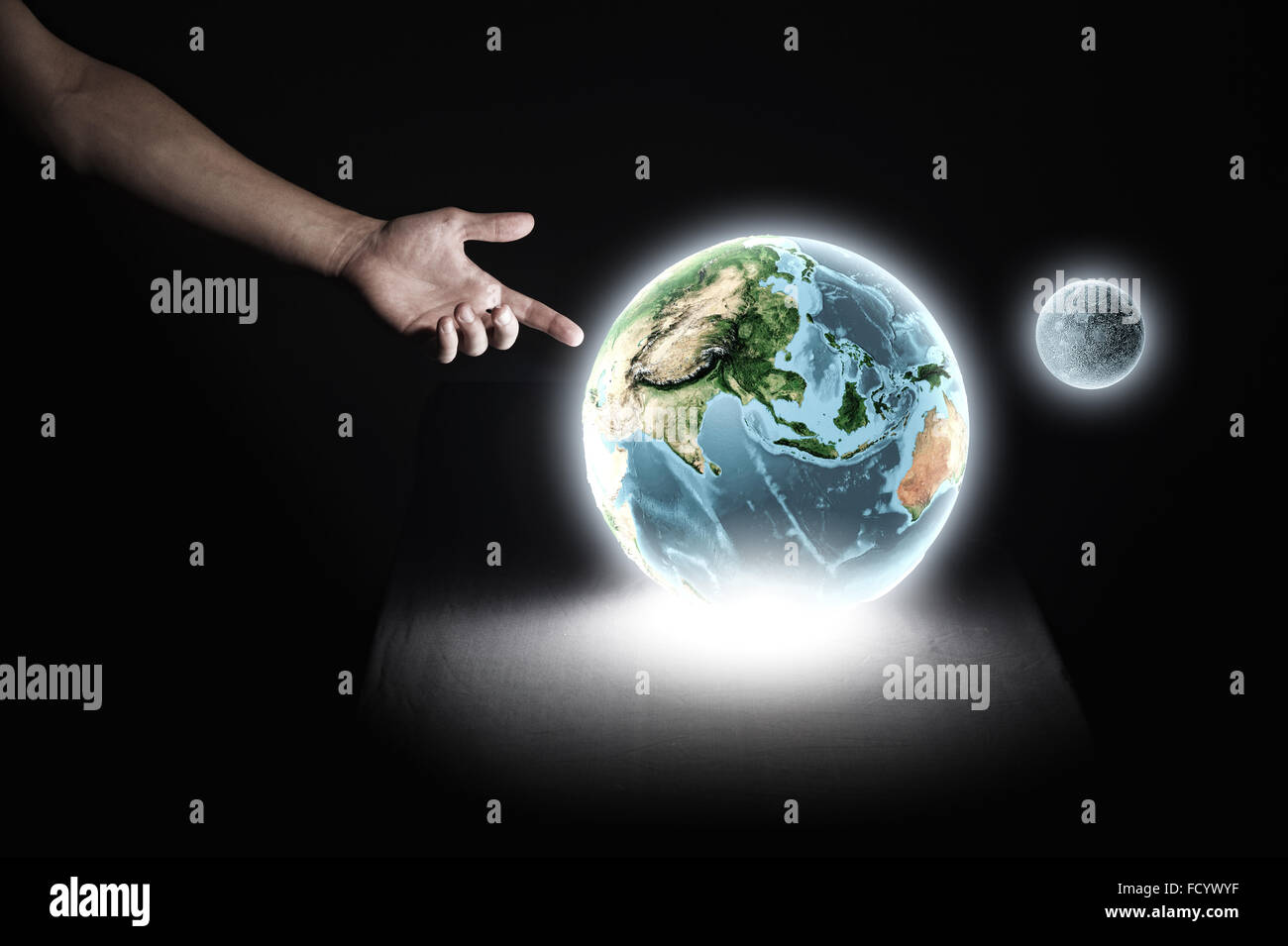 Close up of human hand touching Earth planet with finger. Elements of ...