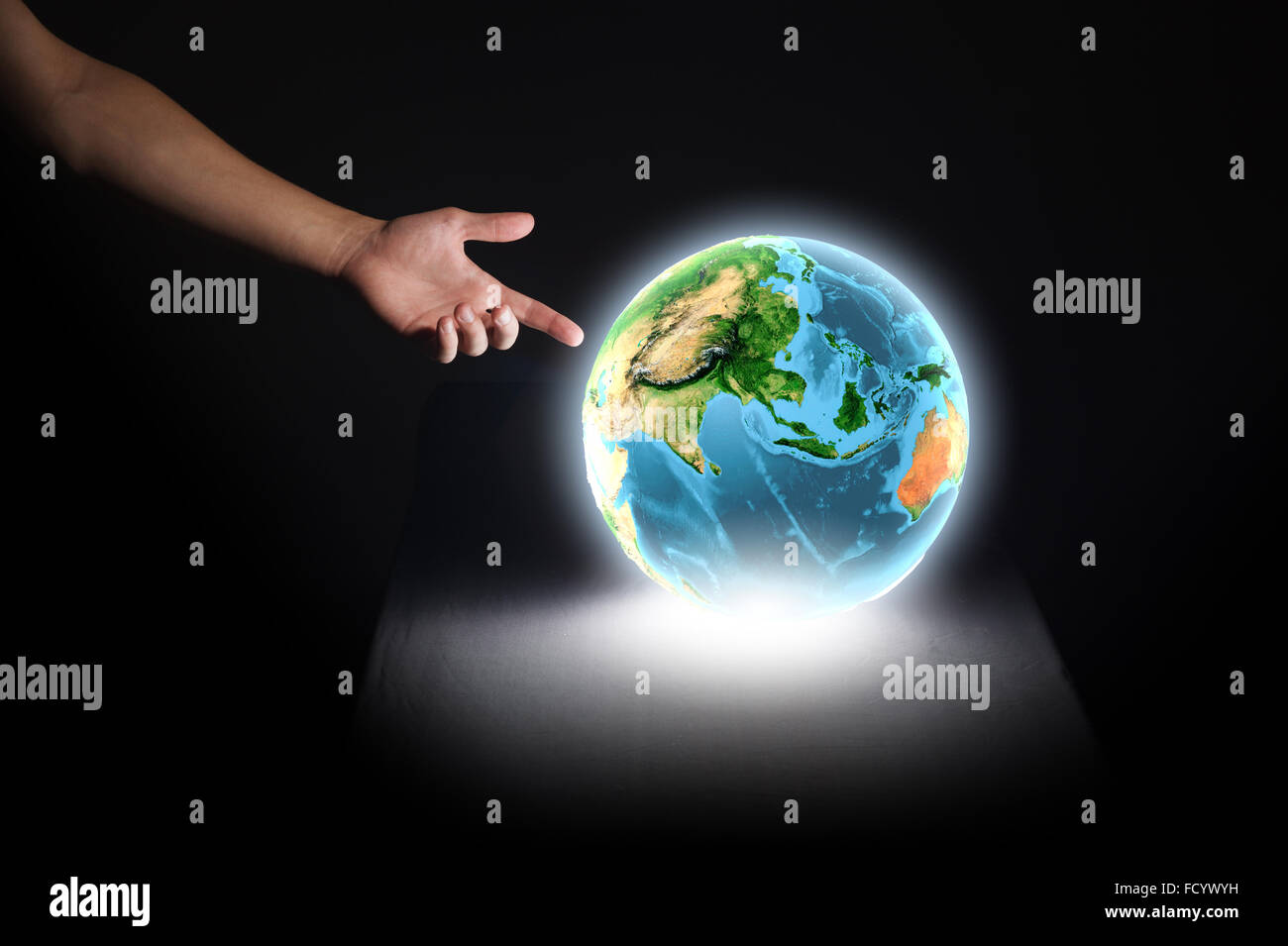 Close up of human hand touching Earth planet with finger. Elements of ...